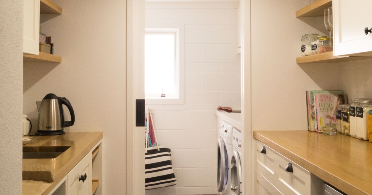 Self-closing Cavity Slider Divides Kitchen and Laundry Spaces by CS For ...